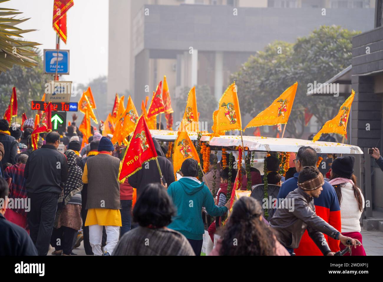 Huge crowd of hindu devotees walking along holding flag celebrating the ...