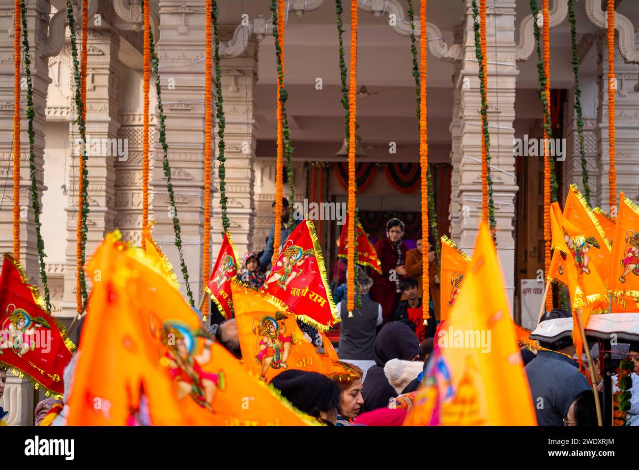 Zoomed shot showing crowd of people carrying flag celebrating the Pran ...