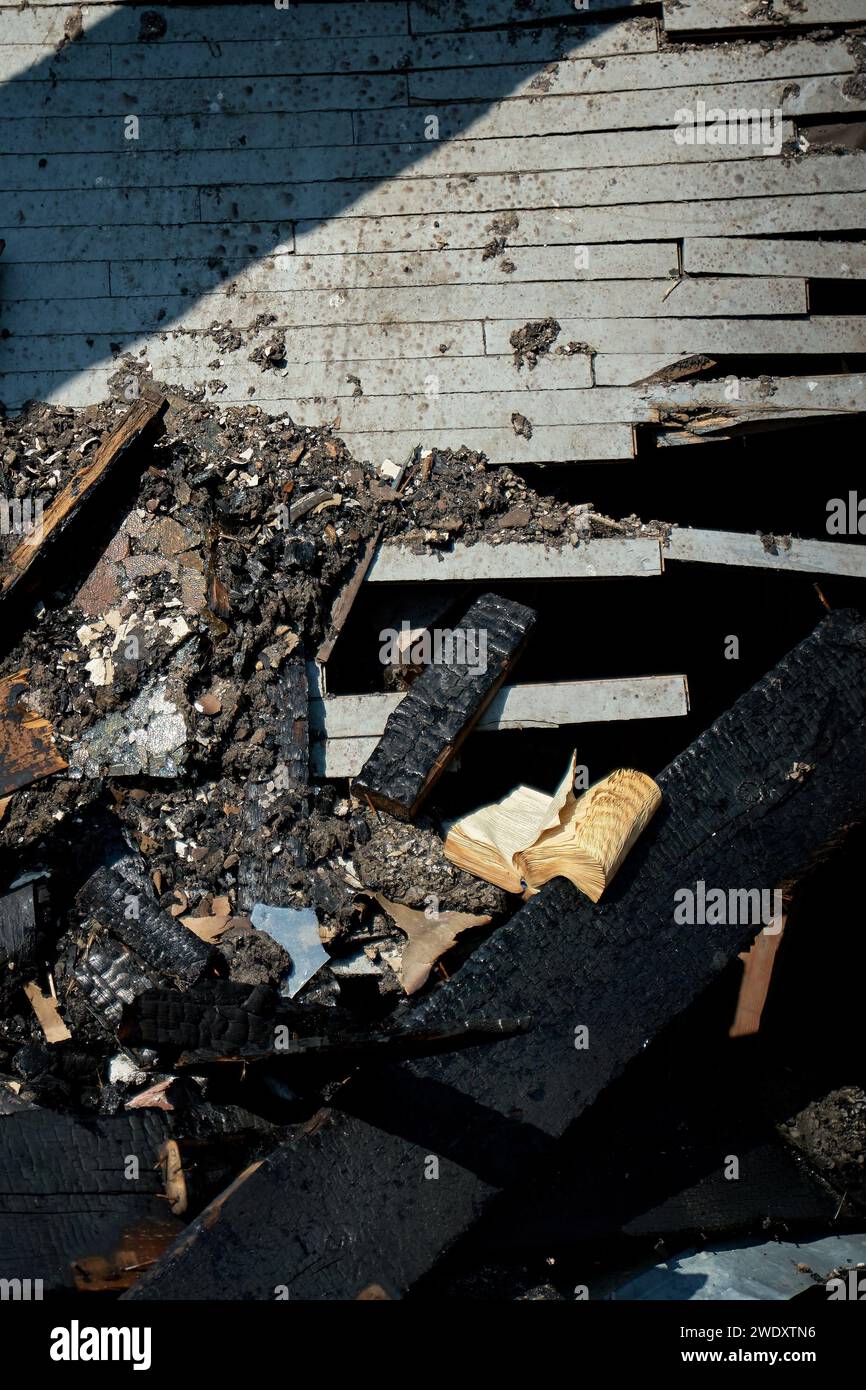 A burnt-out old wooden building after a fire. Charred beams after the ...