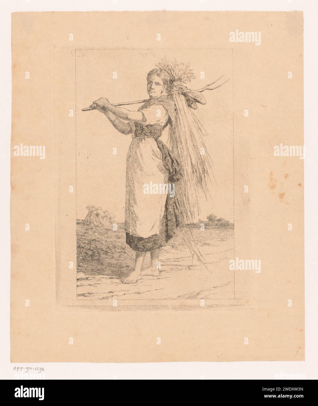 Young woman barefoot with a pitchfork over her shoulder through the ...