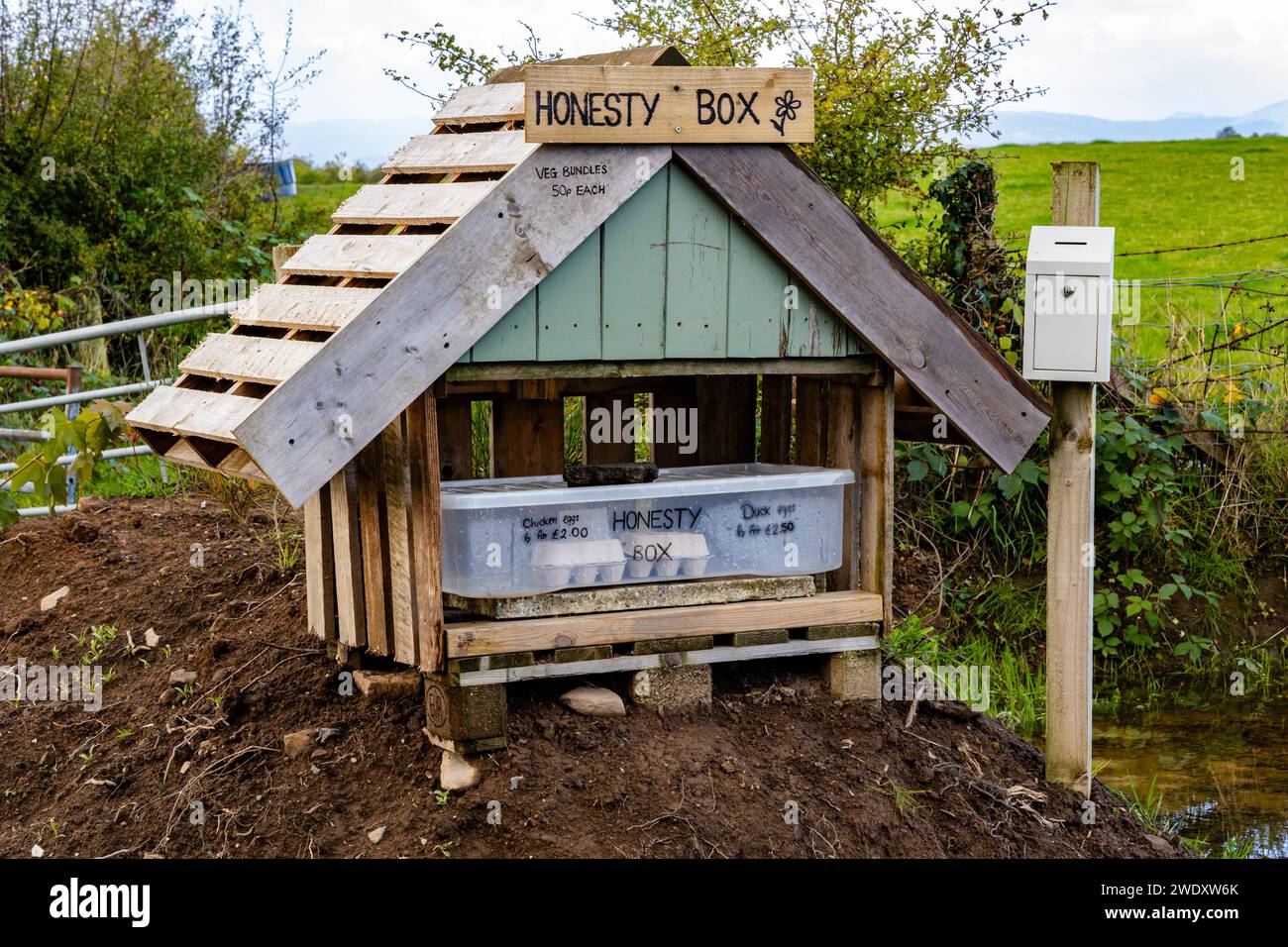 large roadside wooden structure, labelled as an honesty box with ...