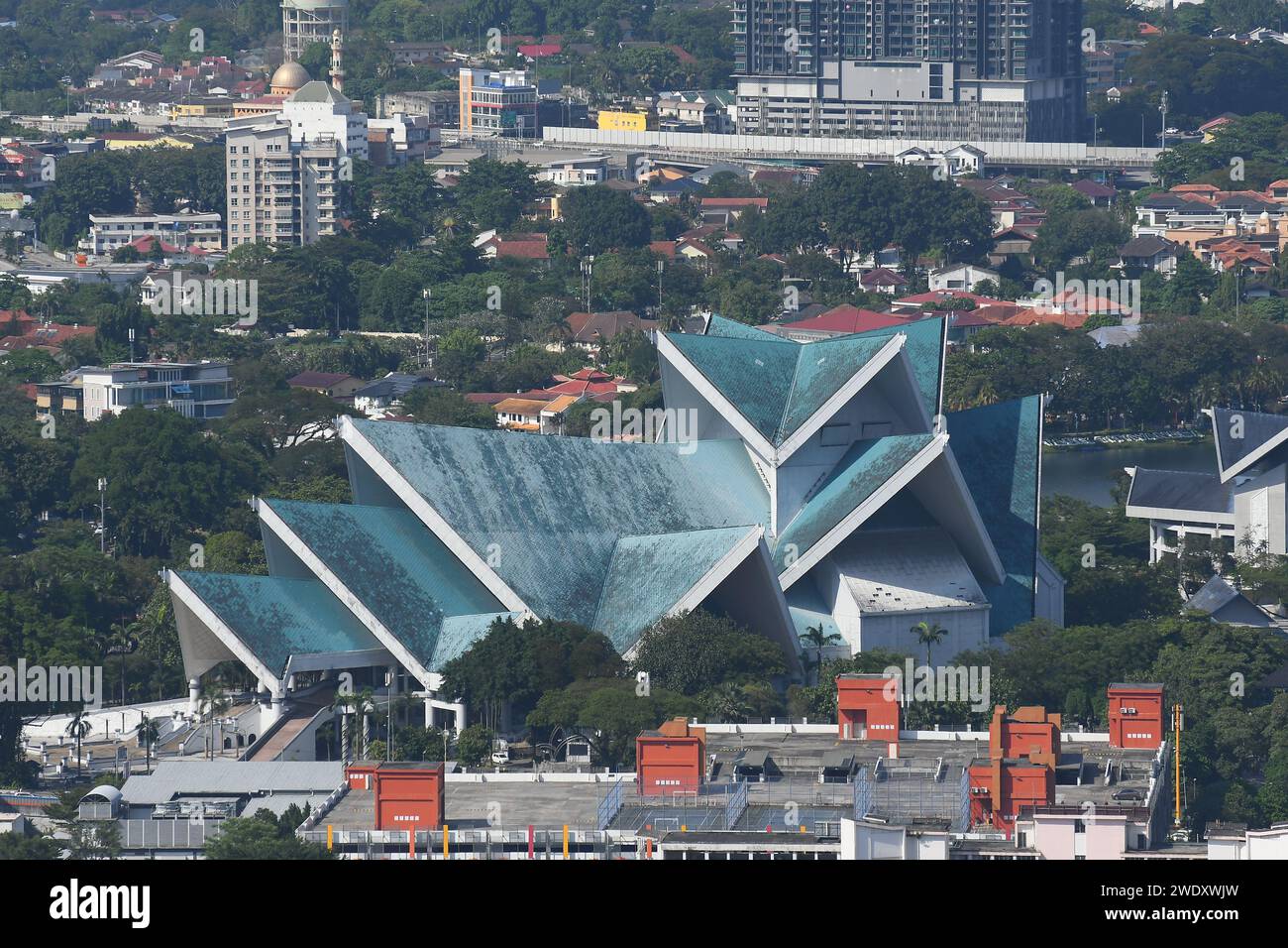 A spacious structure featuring a vibrant blue rooftop, situated on a ...