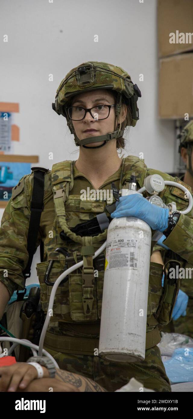 ADF member holding an oxygen tank during a casualty care training ...
