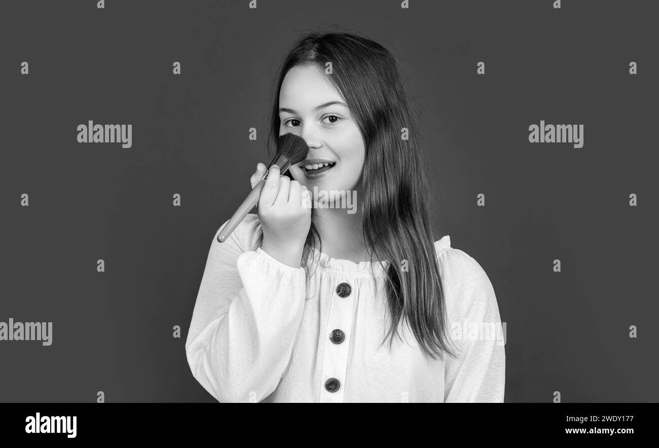 cheerful child apply powder on face with makeup brush Stock Photo - Alamy