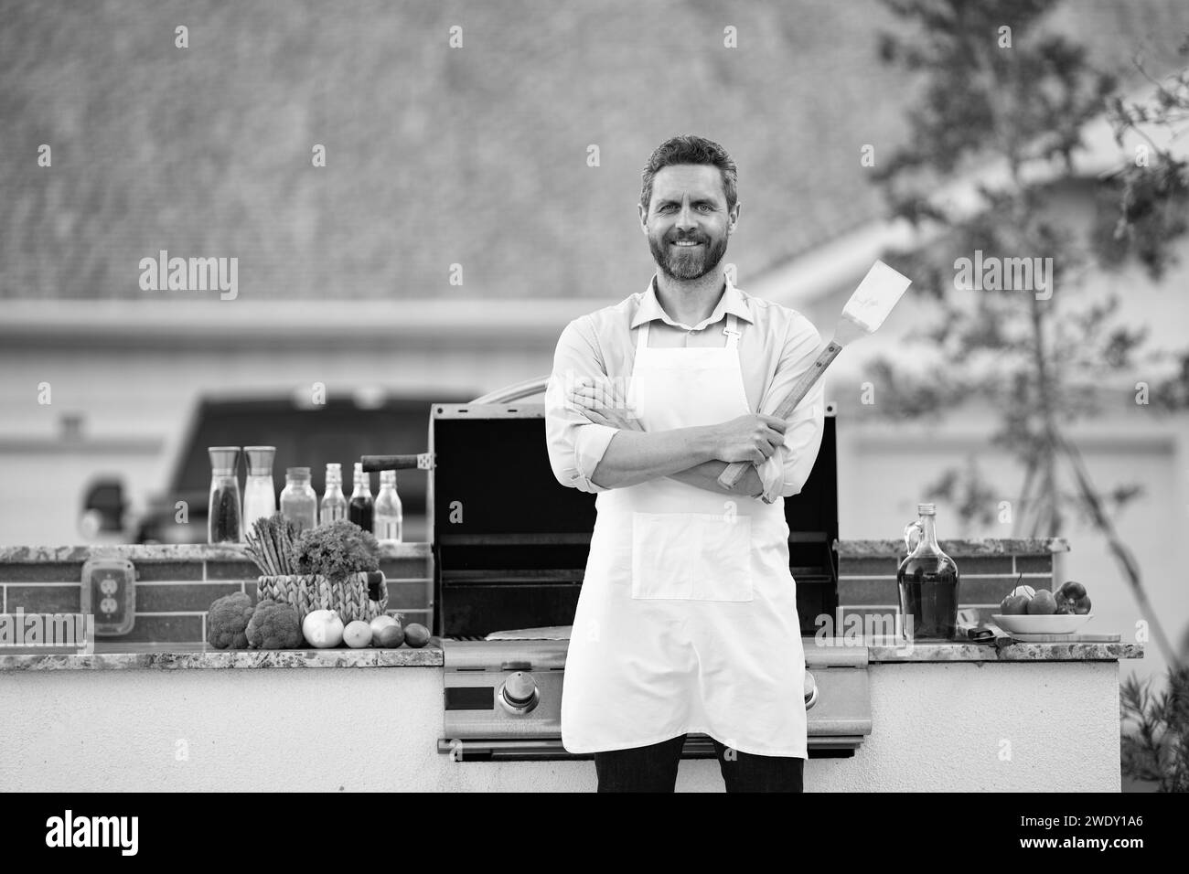 chef man at barbecue and grill hold utensil, copy space. chef man at ...