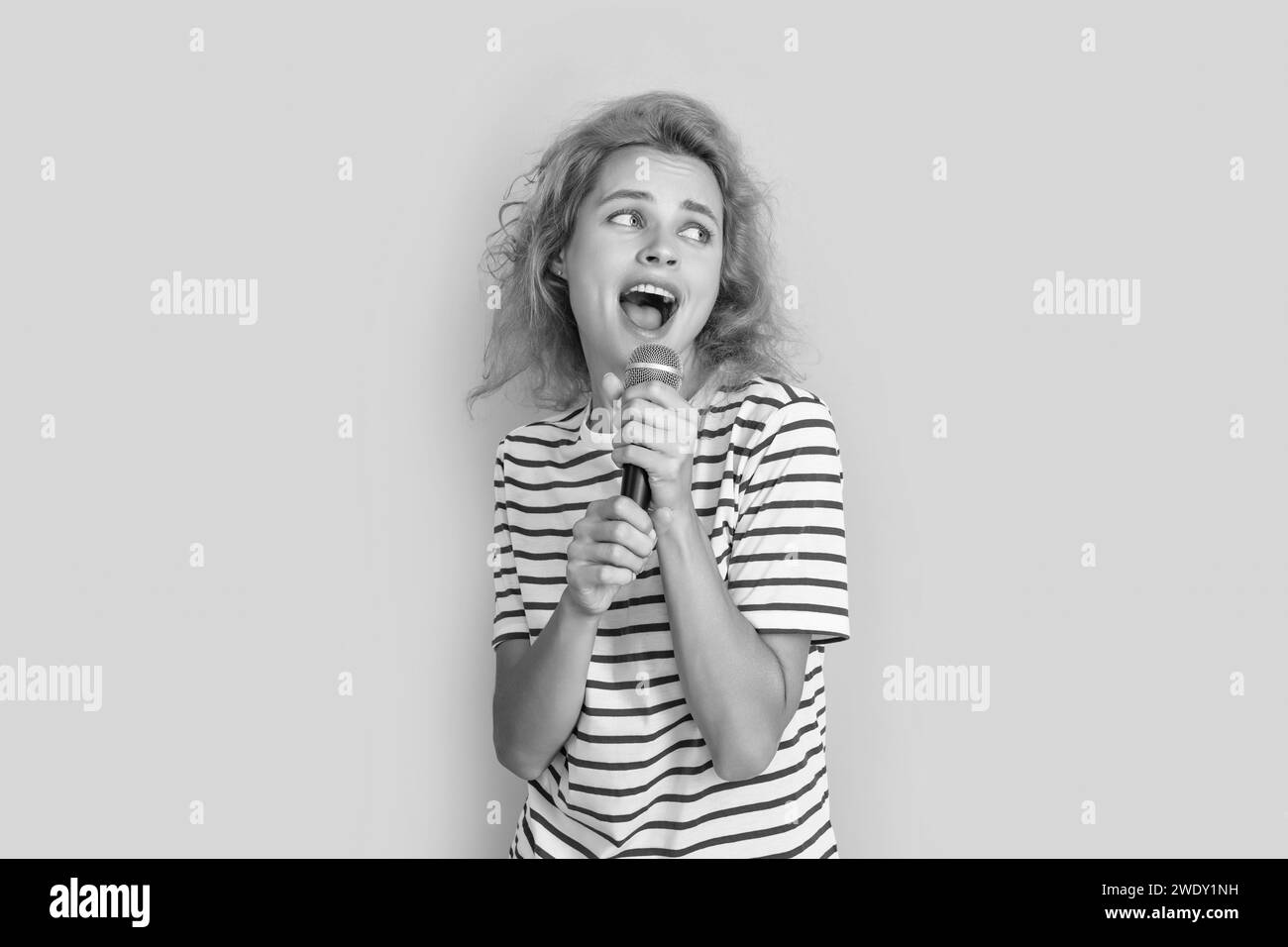 emotional girl singer isolated on yellow background. young singer girl ...