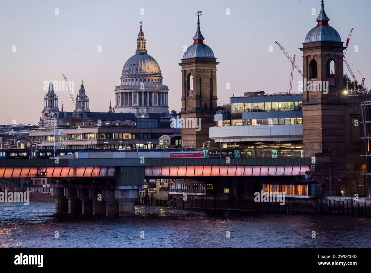 Cannon Street railway bridge illuminated at night and St Paul's ...