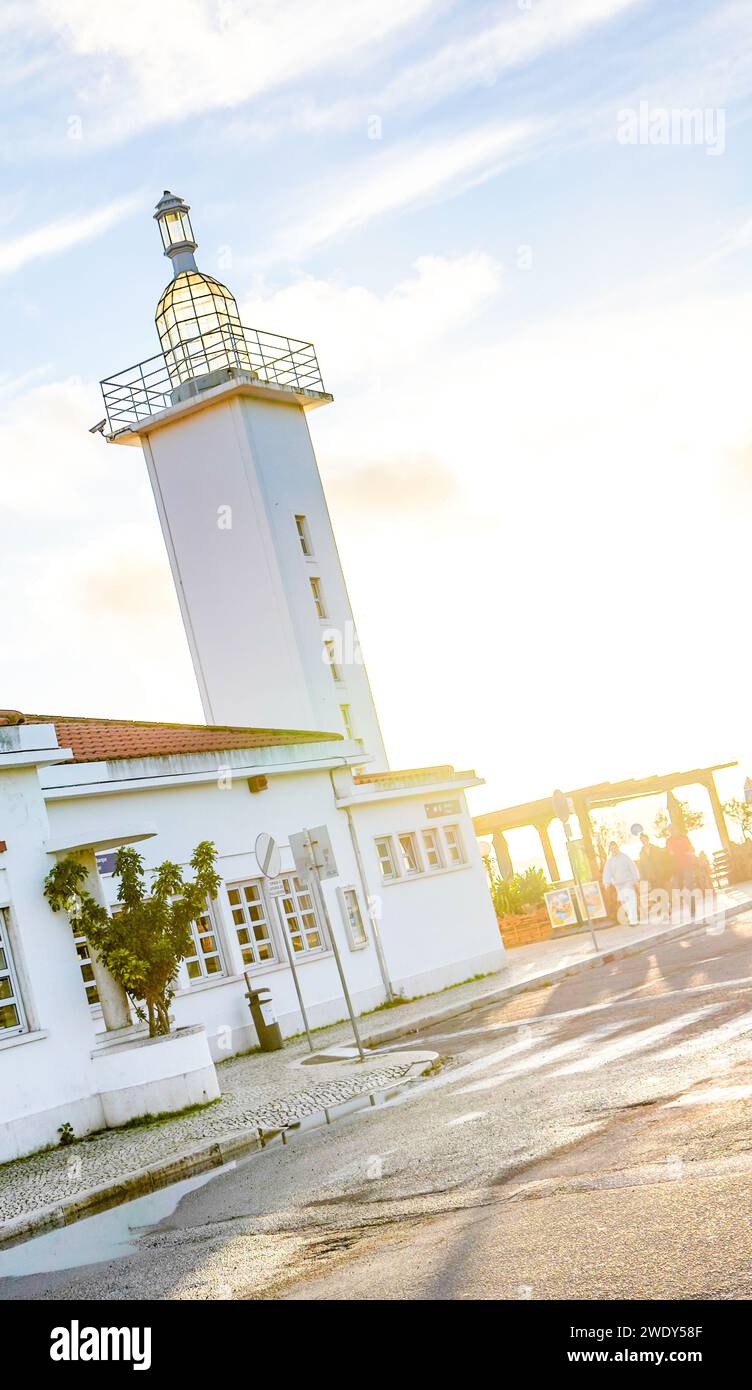 Historic Belém ferry station lighthouse tower with golden sunlight ...