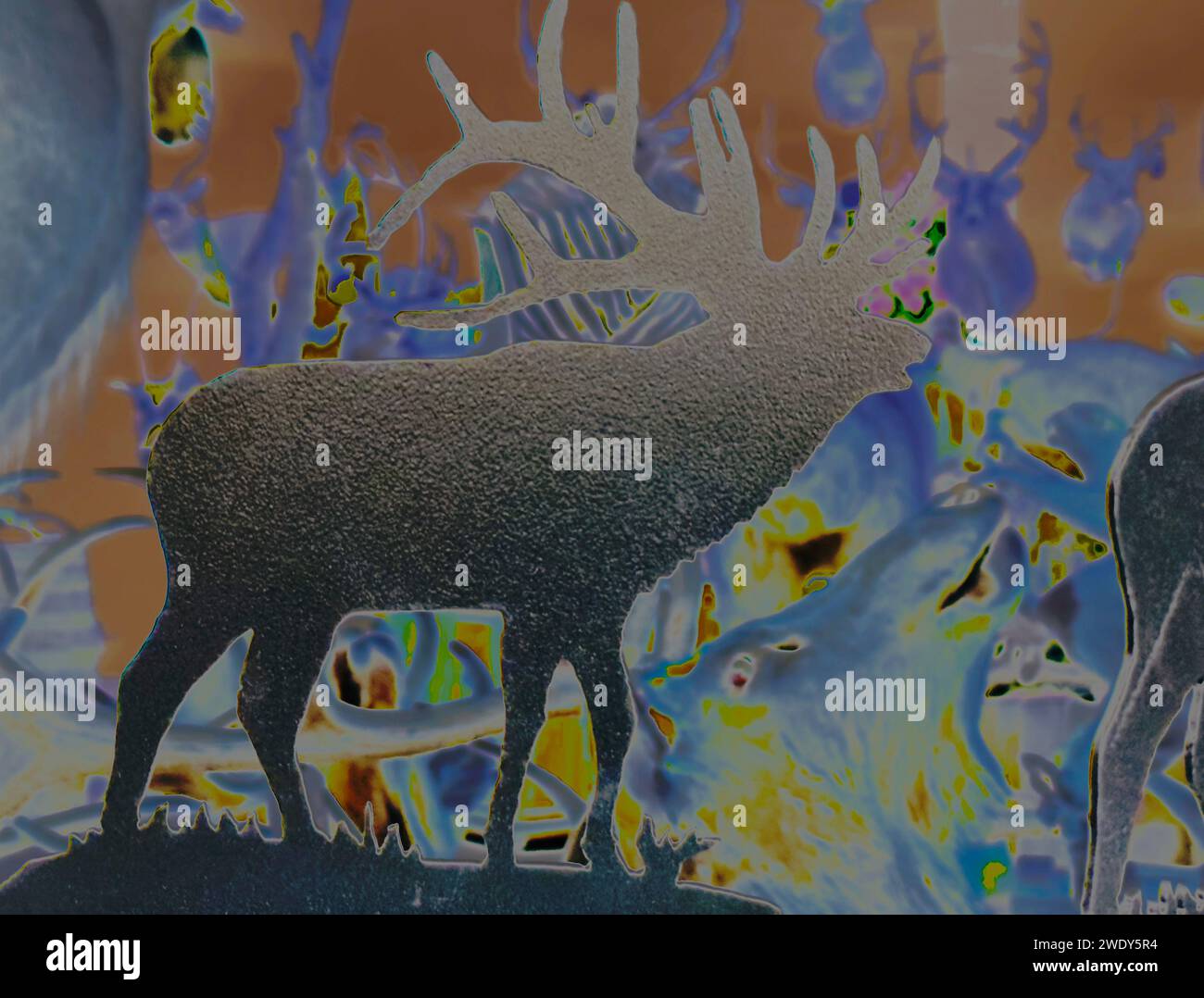 A silhouette of an elk statue with antlers is seen with abstract ...