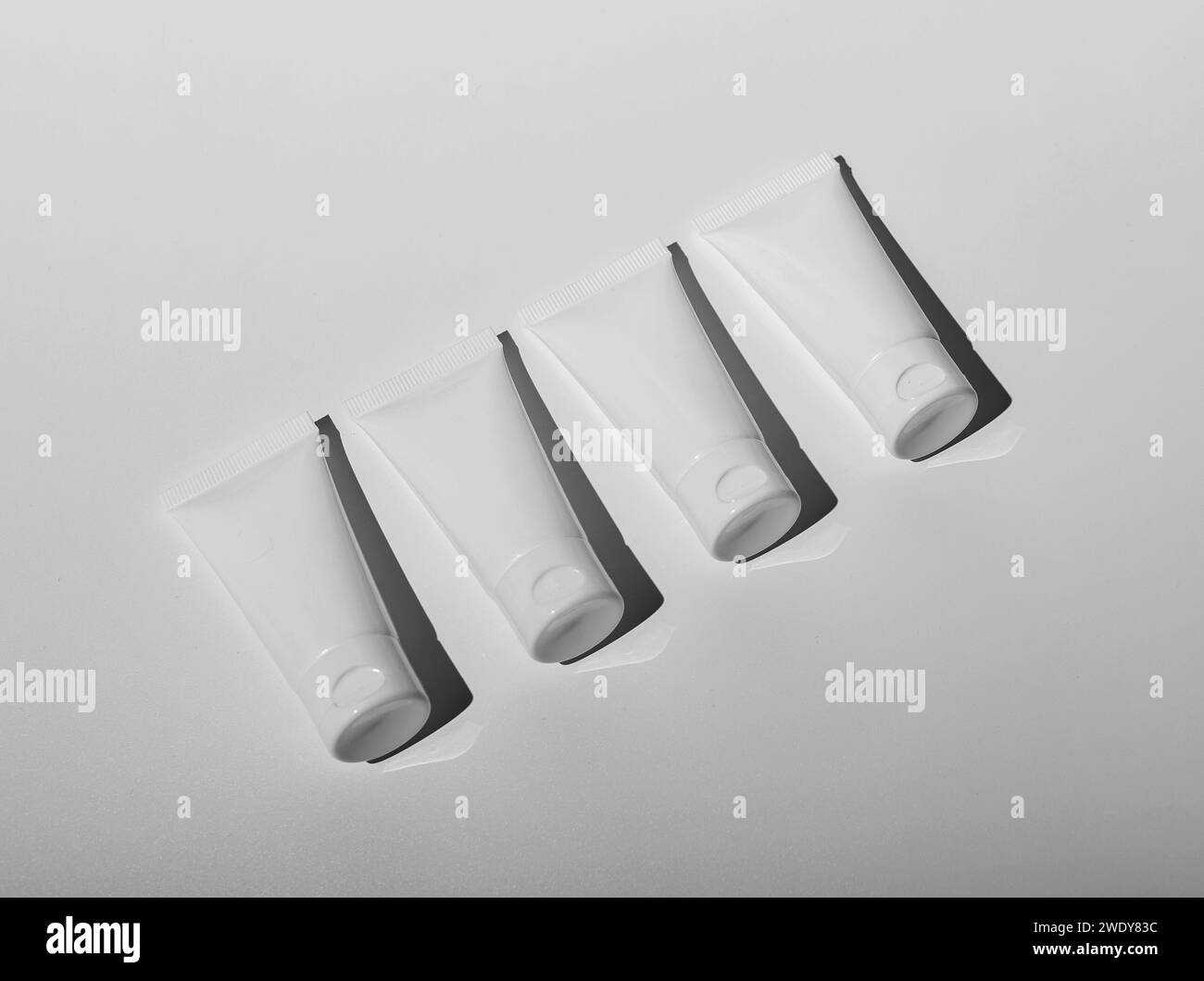 Cream tubes mockups laying in row. Cosmetic products, face skin mask ...