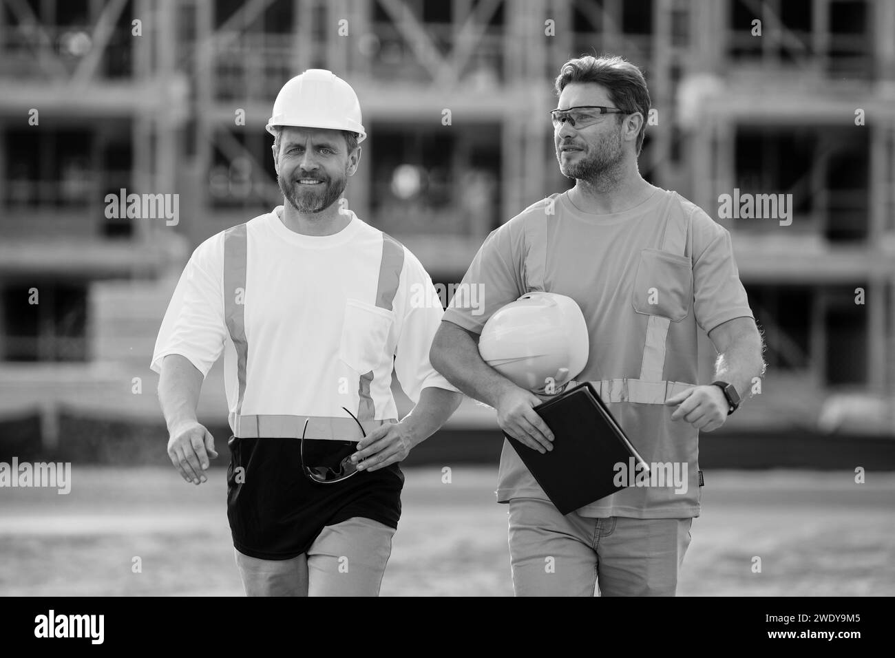 Two Architect Men Have Construction Project On Clipboard Photo Of
