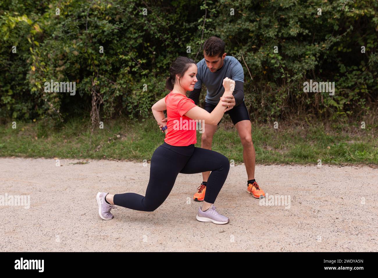 Outdoor Fitness Coaching: Two Individuals Engaging in a Stretching ...