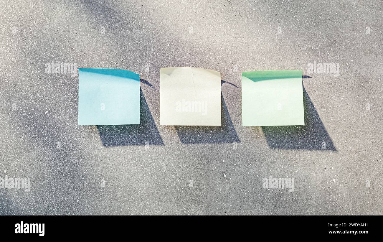 Three Blank Sticky Notes Pinned to a Textured Grey Wall in Natural ...