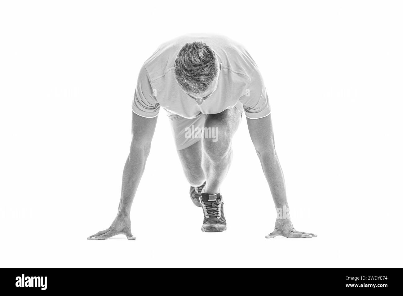 Male sportsman getting ready to run Black and White Stock Photos ...