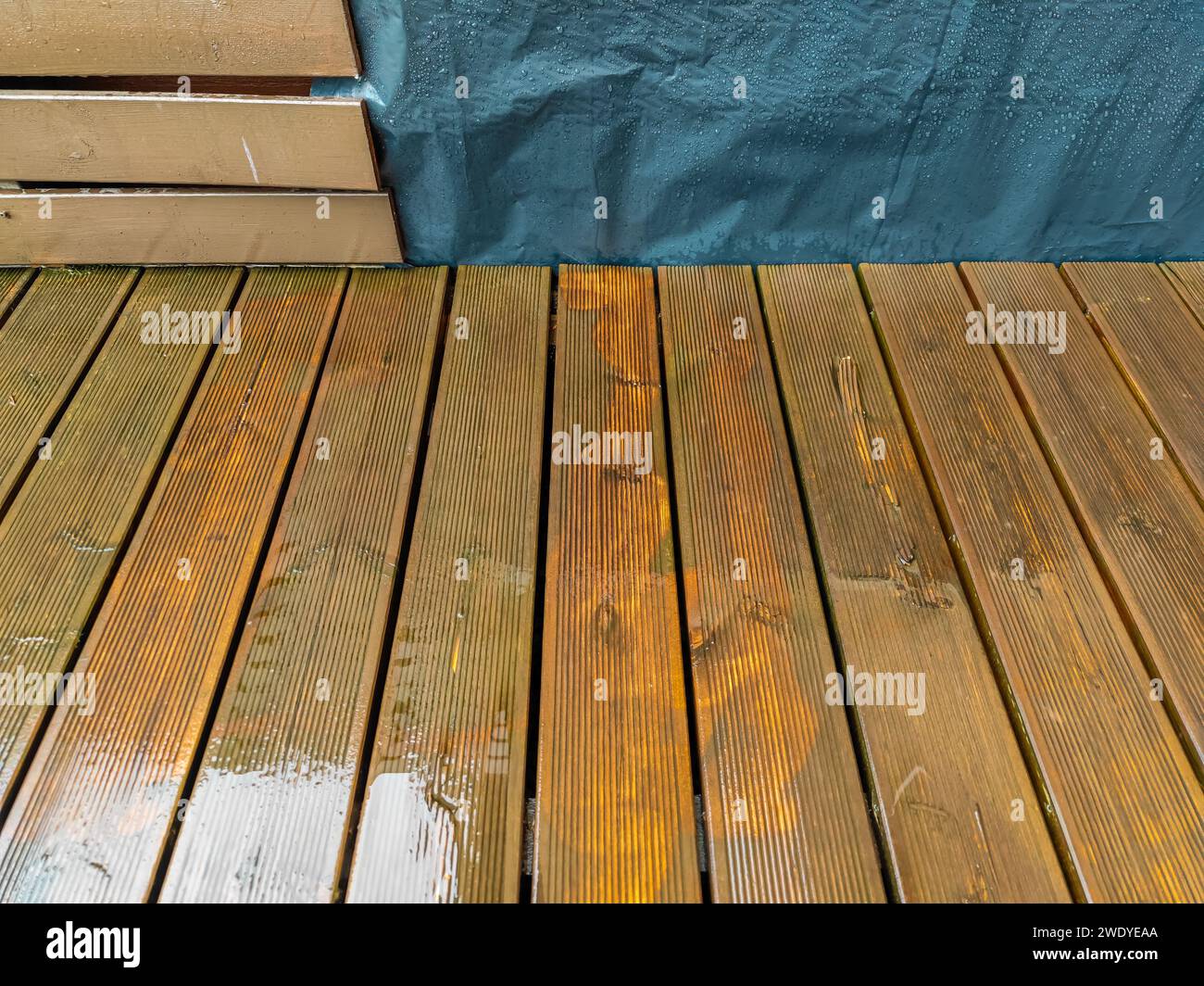 Wooden brown terrace prepared for oiling and painting with walls and ...