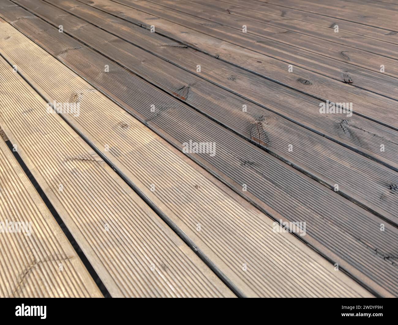 Partially painted and partly cleaned fluted wood terrace impregnated ...