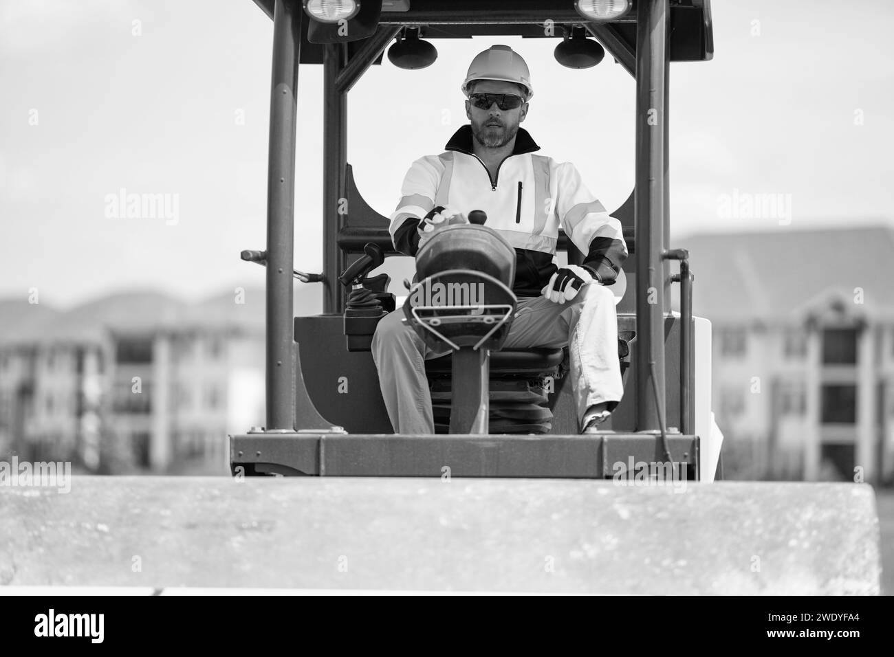man worker at construction machinery outdoor. A construction worker ...
