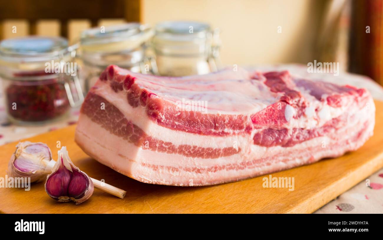 cooking traditional homemade lard with spices. pork belly with layer on ...