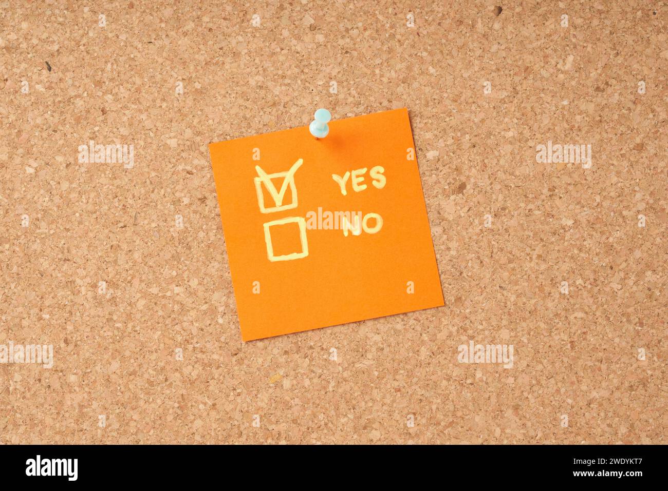Office cork board with attached piece of paper with words yes or no ...