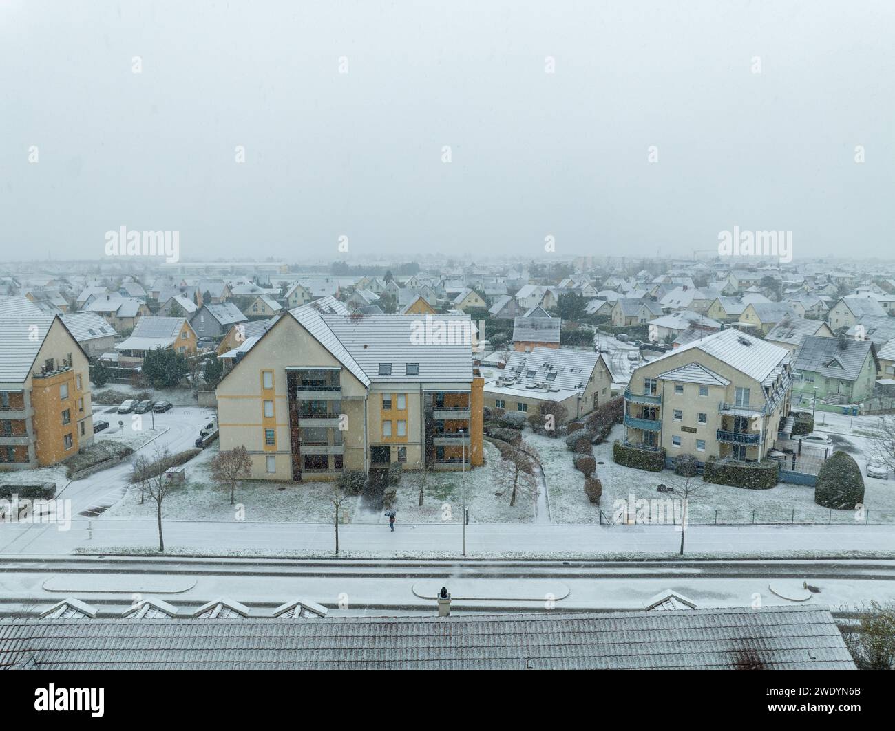 Aerial view of falling snow in the residential area Kingersheim ...