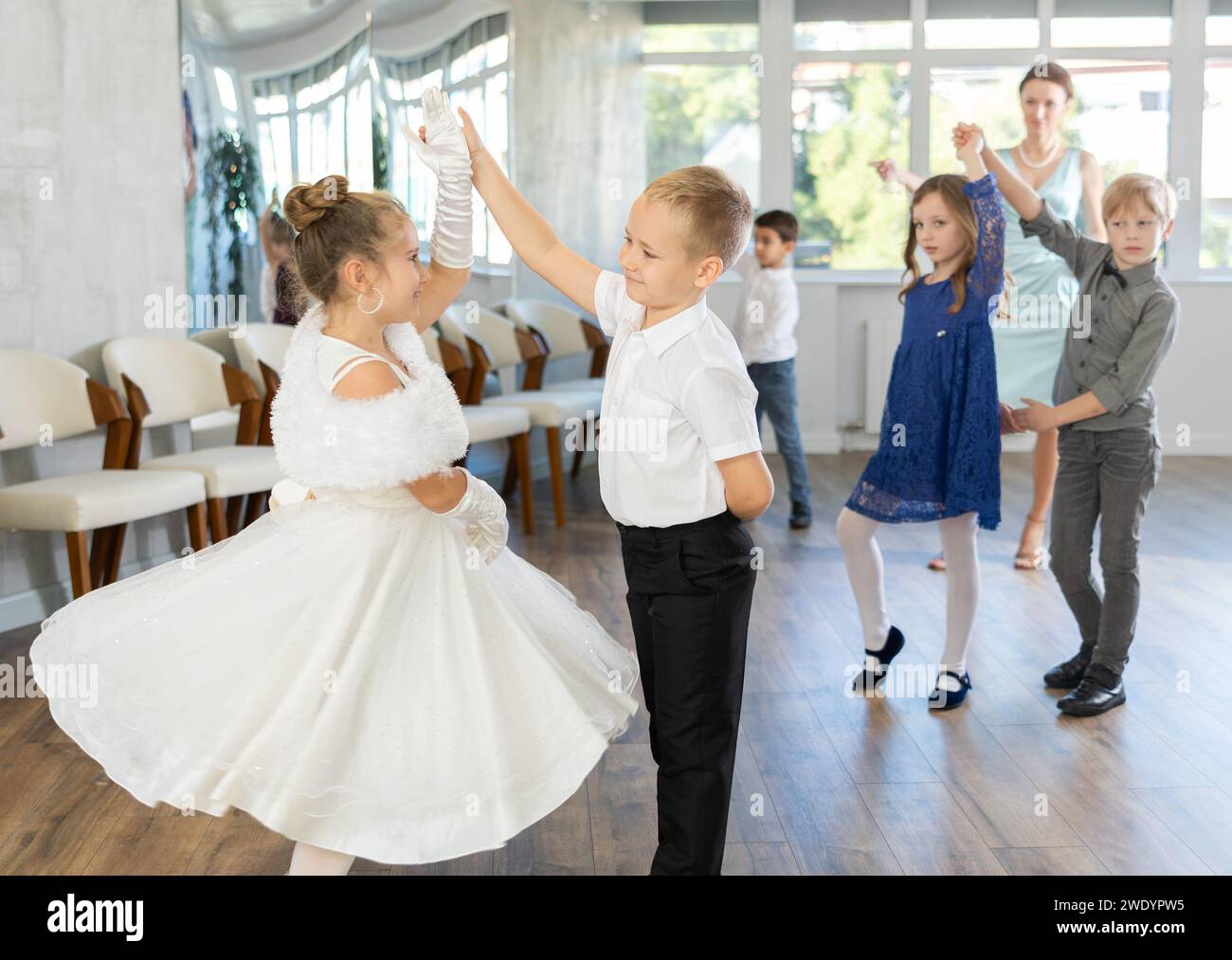 Children dance in pairs at festive matinee Stock Photo - Alamy