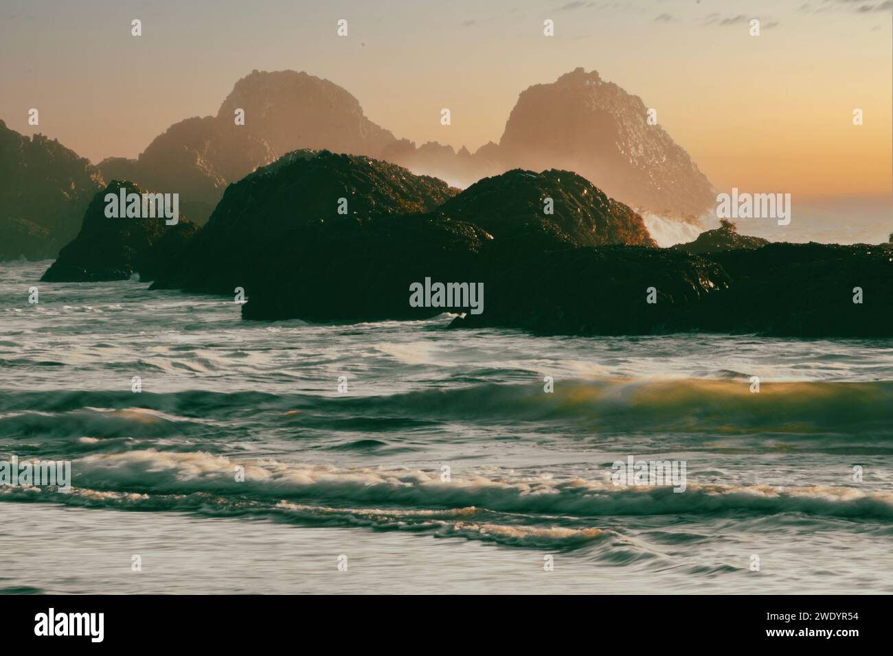 Sunset over the Pacific Ocean at South Seal Point, waves washing over ...