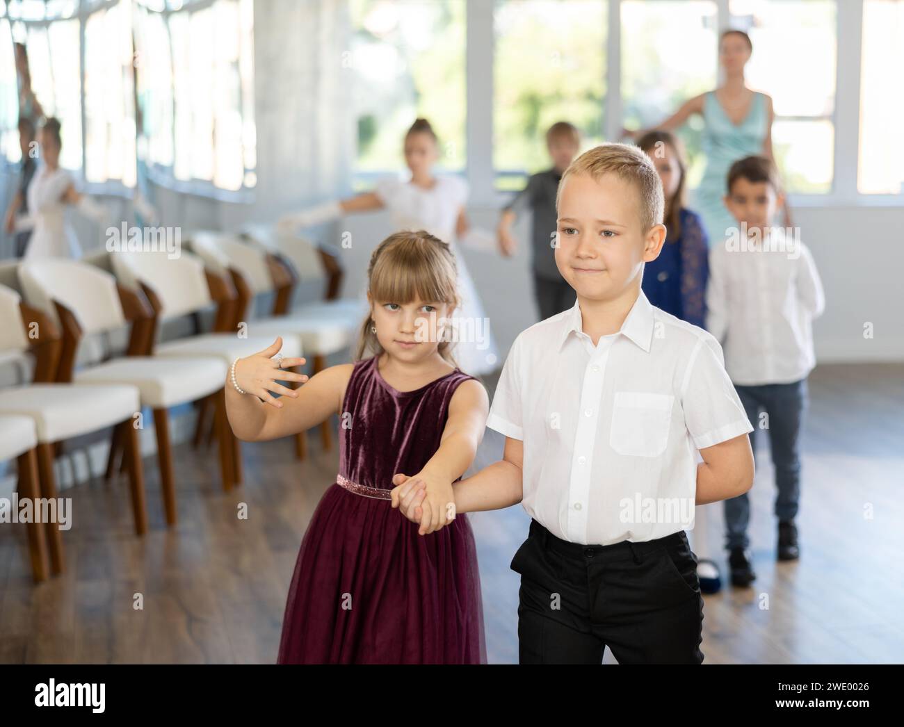 Tween girls ad boys dancing slow partner dance during festive event ...