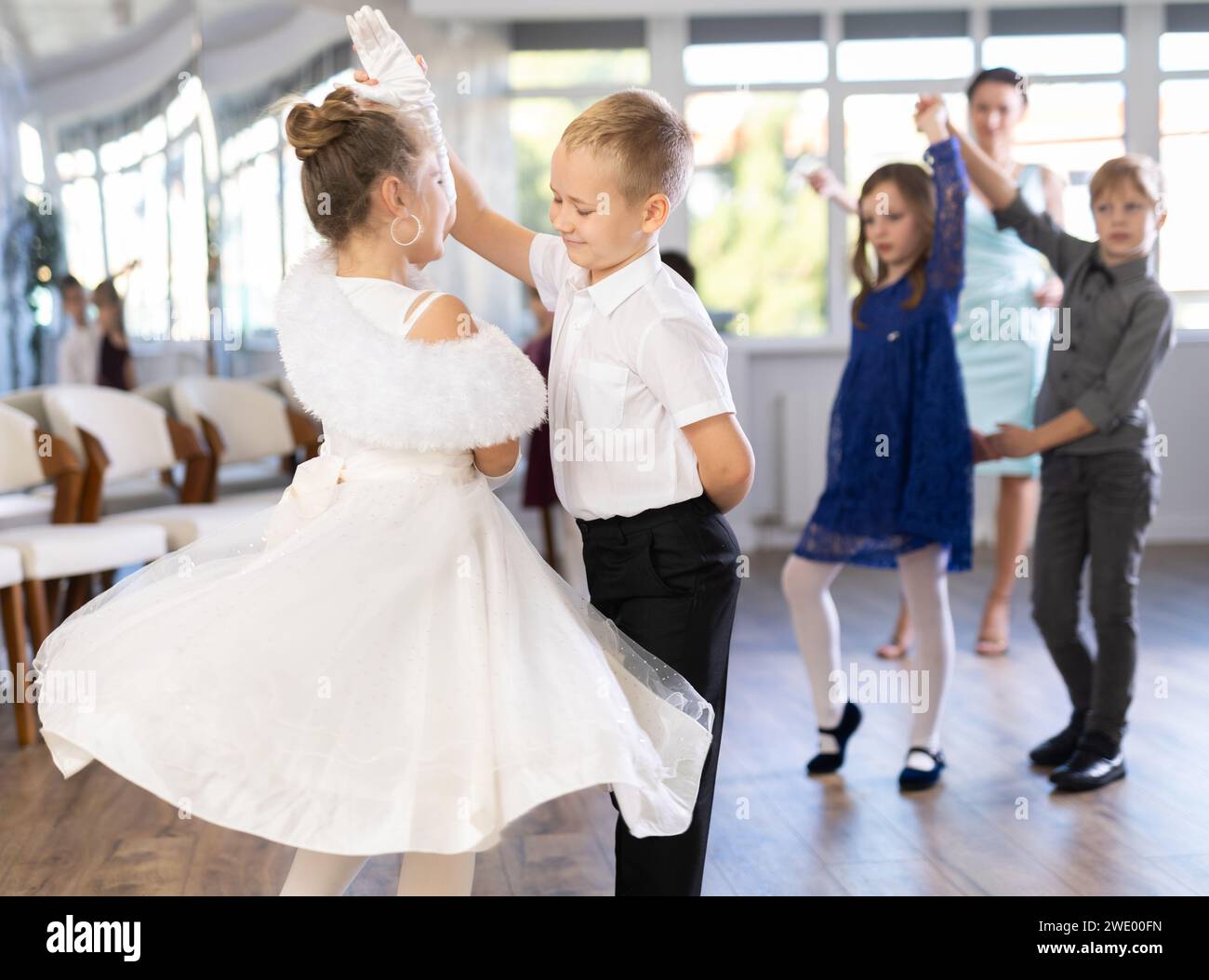 Classical dances performed by preteen children in festive clothes Stock ...