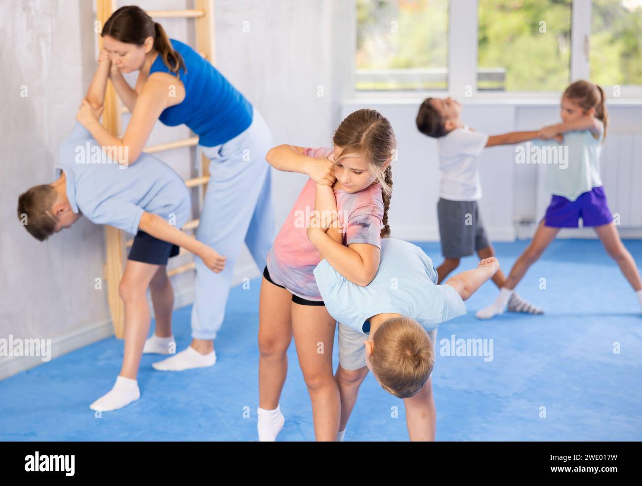 children are working on arm twists Stock Photo - Alamy