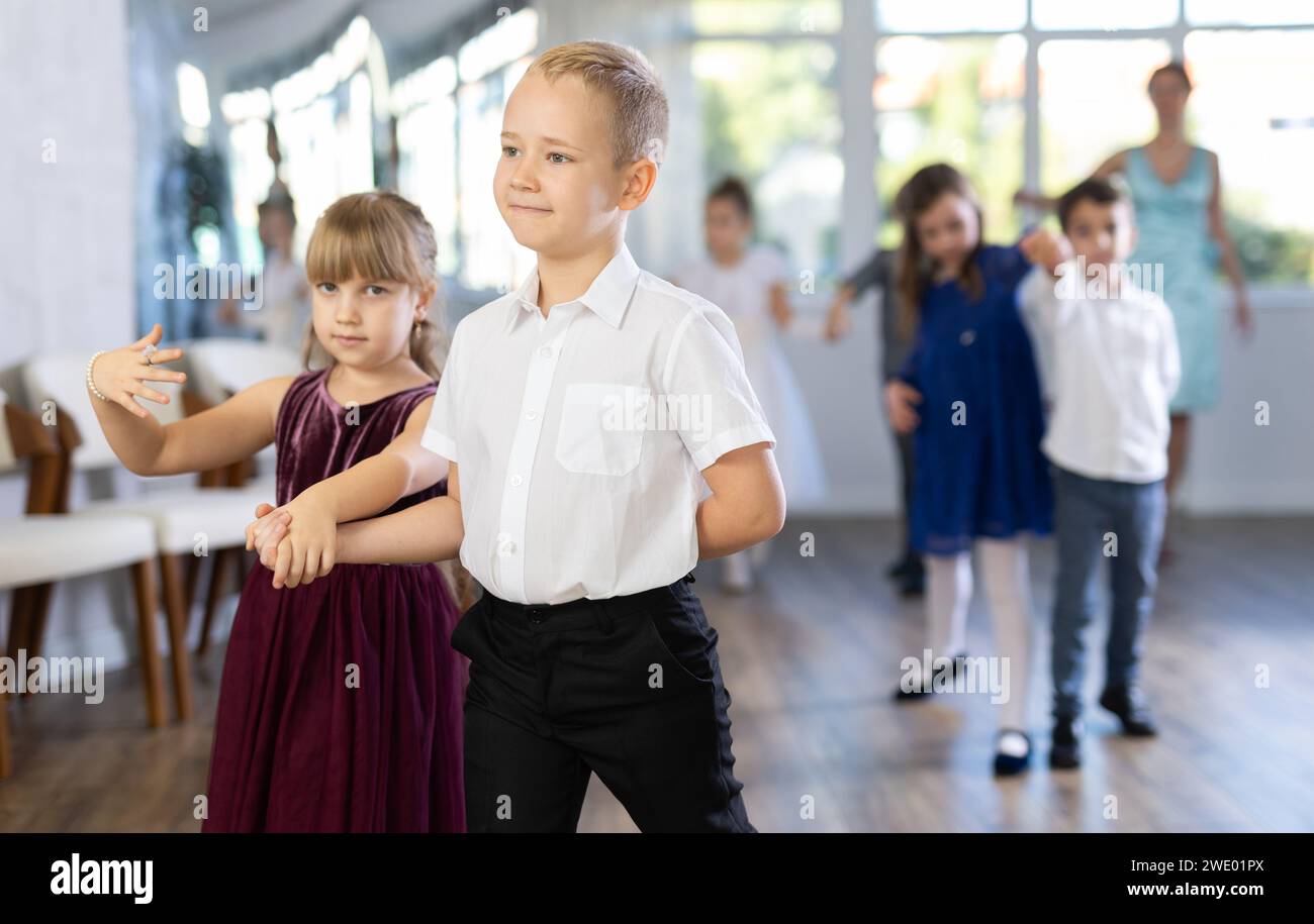 Little children in elegant dresses standing in pairs in dance pose in ...