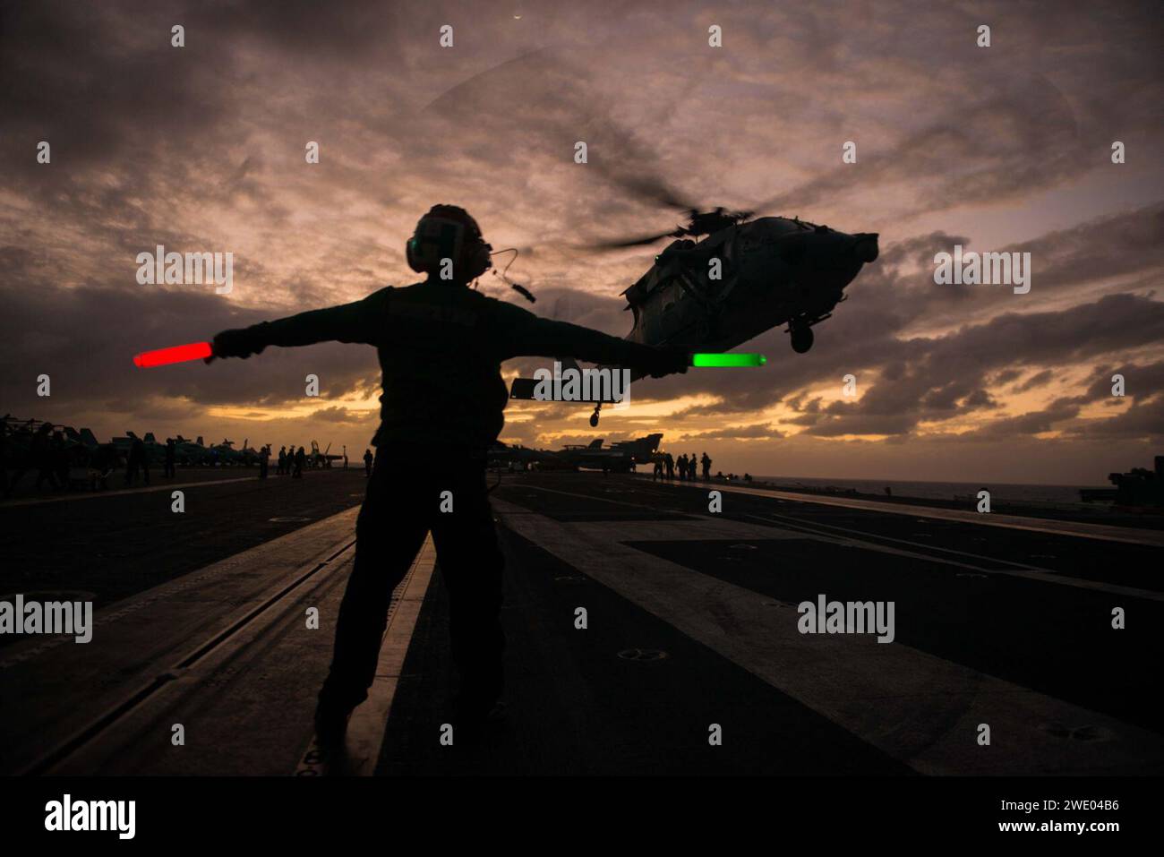 Airman gives take off signal to HSC-14 MH-60S Sea Hawk on USS John C ...