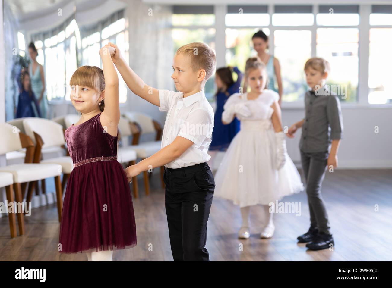 Classical dances performed by preteen children in festive clothes Stock ...