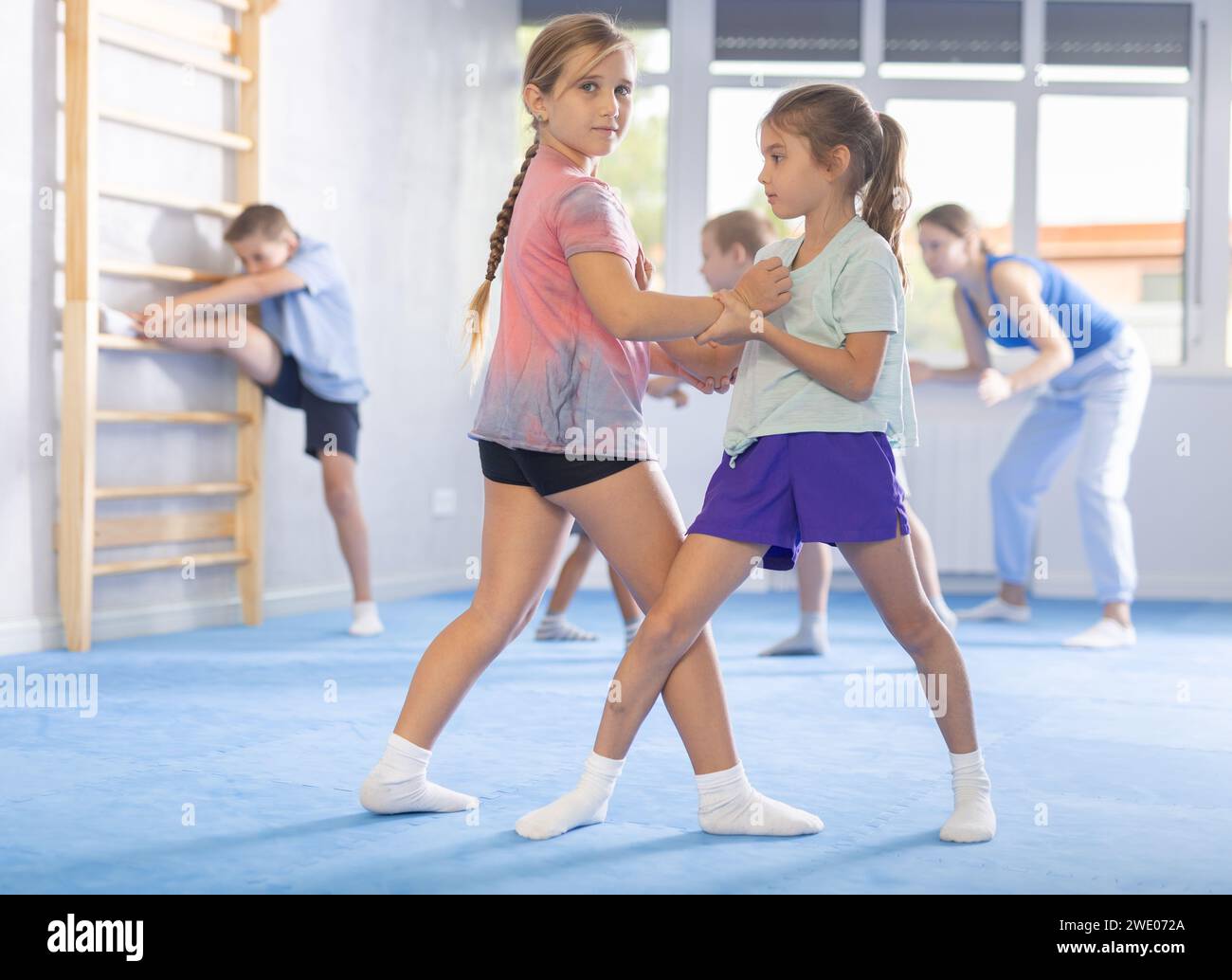 Boys and girls in gym perform basic elements of krav maga self-defense ...