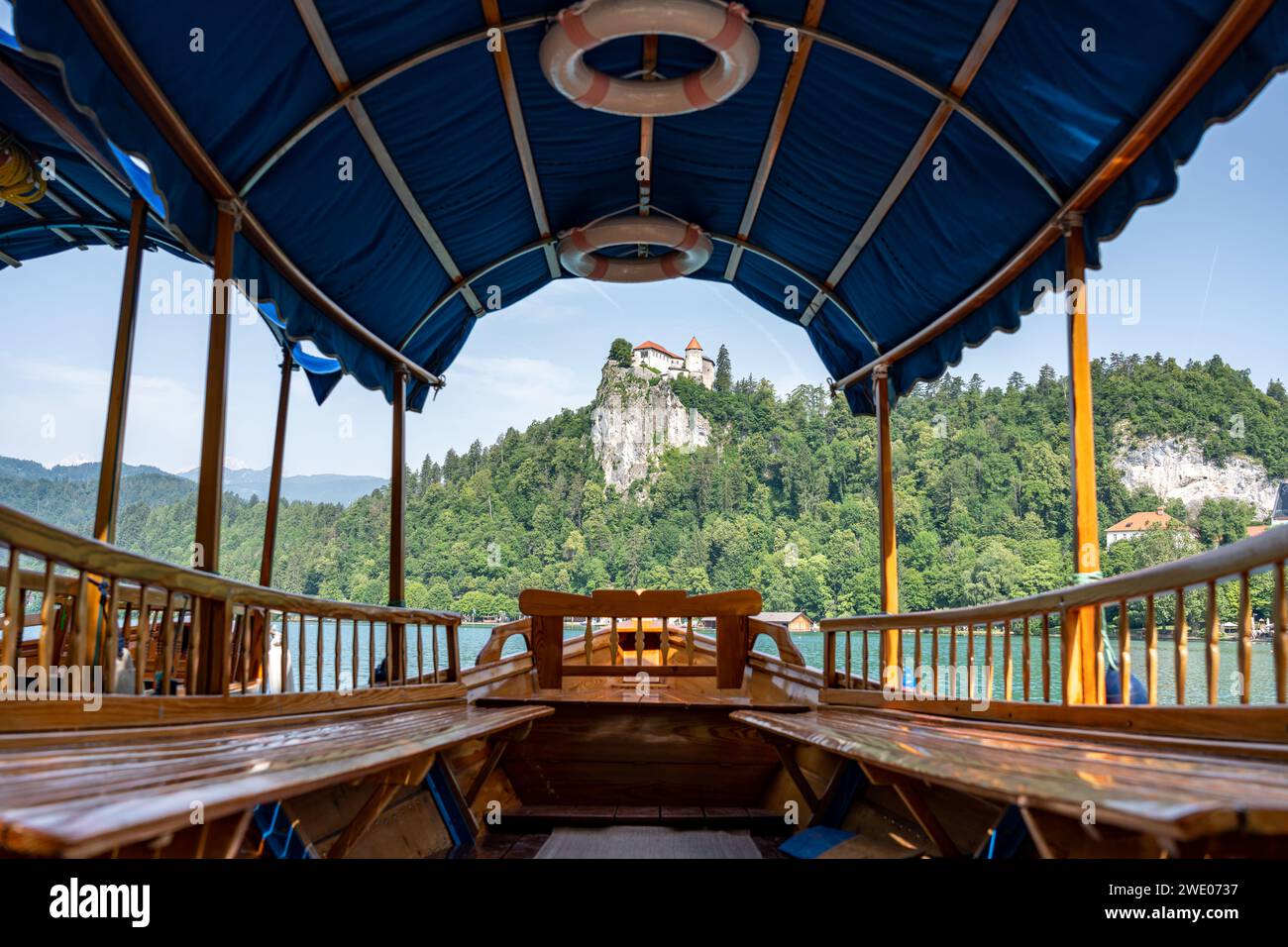 View through the traditional Pletna boat to Bled Castle on top of the ...
