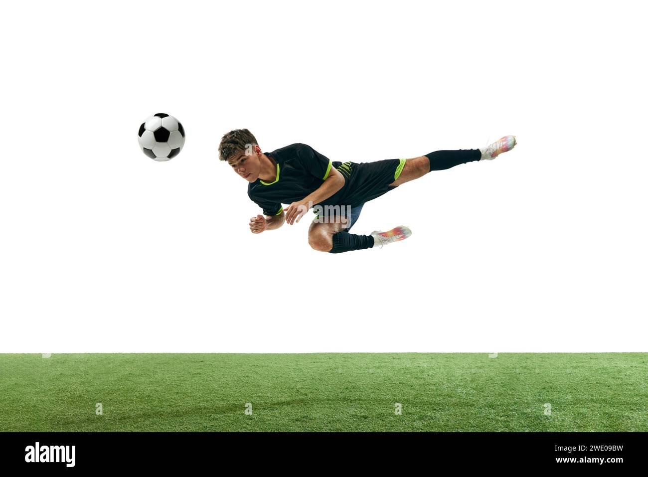 Dynamic image of young man, football player in motion, hitting ball ...