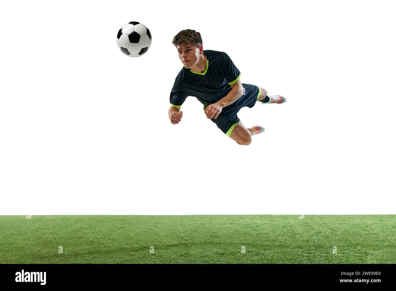 Dynamic image of young man, football player in motion, hitting ball ...