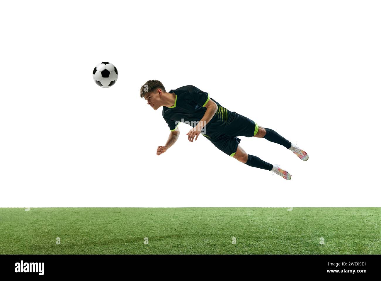 Dynamic image of young man, football player in motion, hitting ball ...