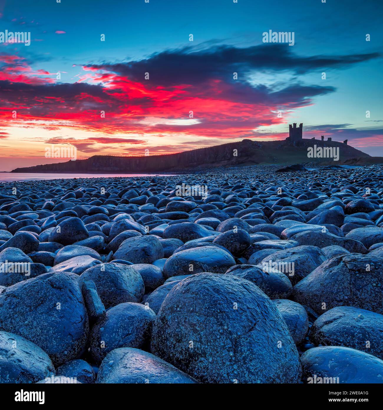 Sunrise at Dunstanburgh Castle in Northumberland looking towards ...