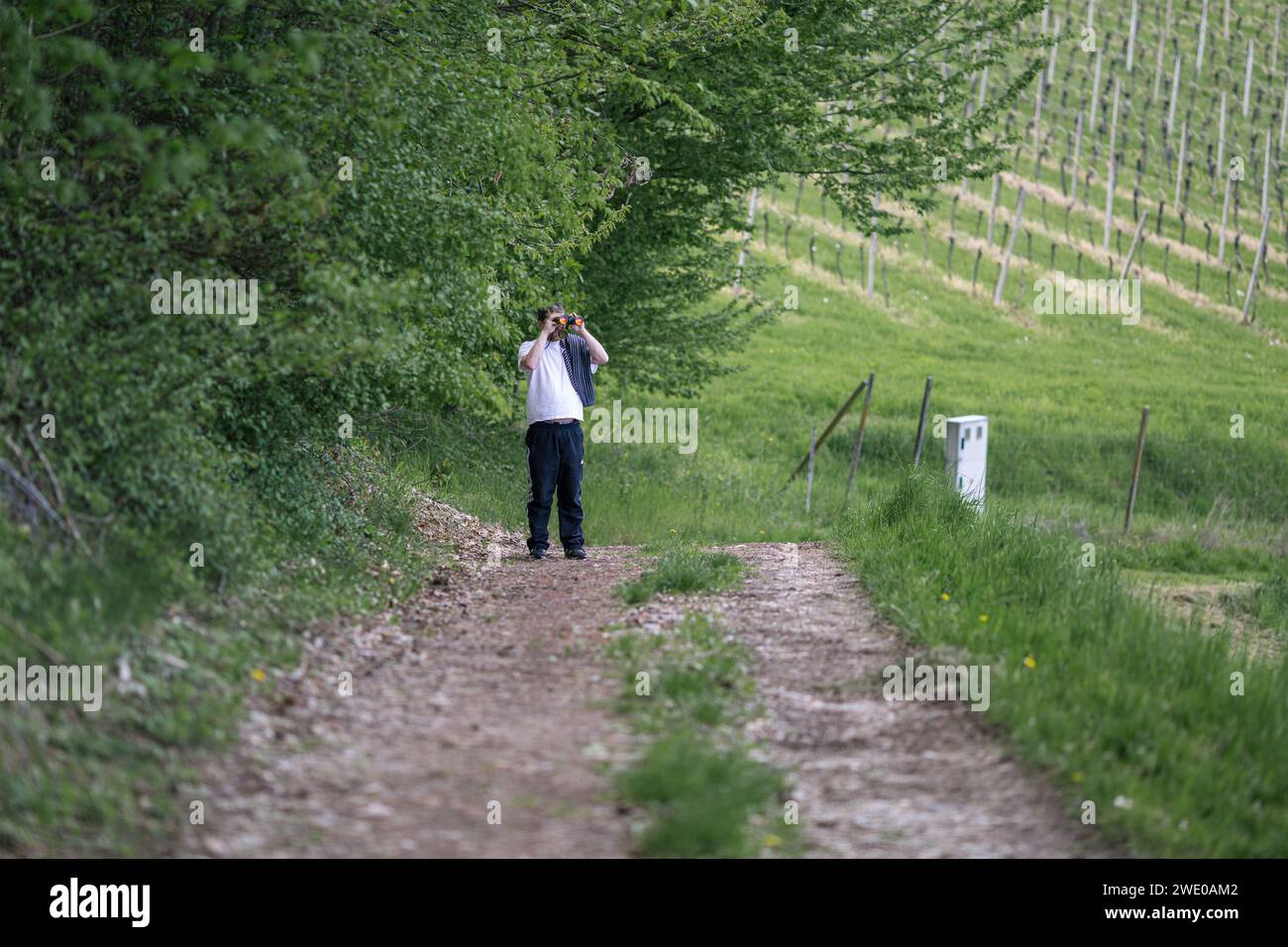 A man watching and observing with binoculars Stock Photo - Alamy