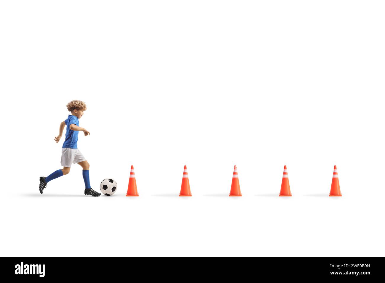 Full length profile shot of a boy running with a football between ...