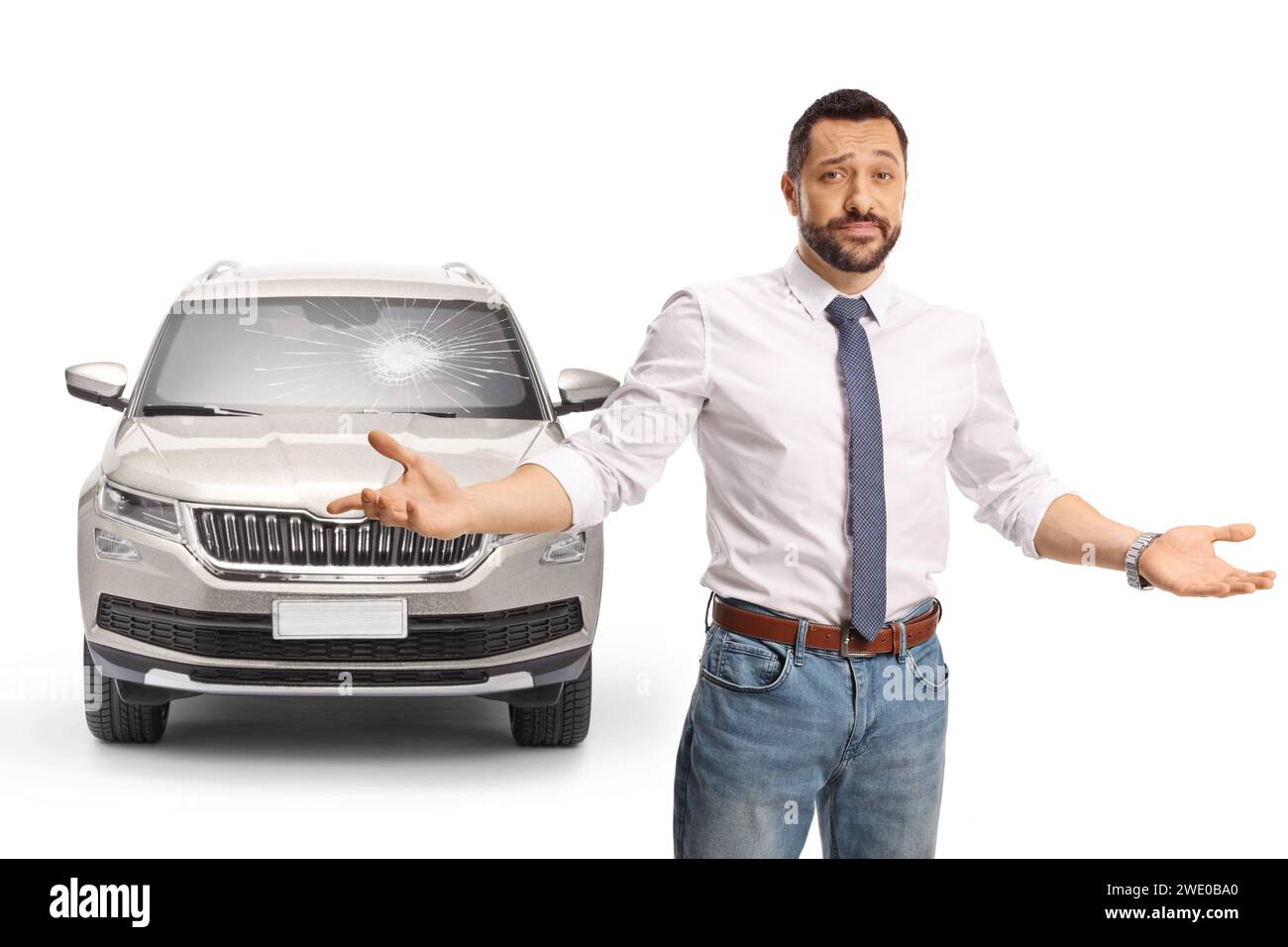 Confused driver standing in front of a SUV with cracked windscreen ...