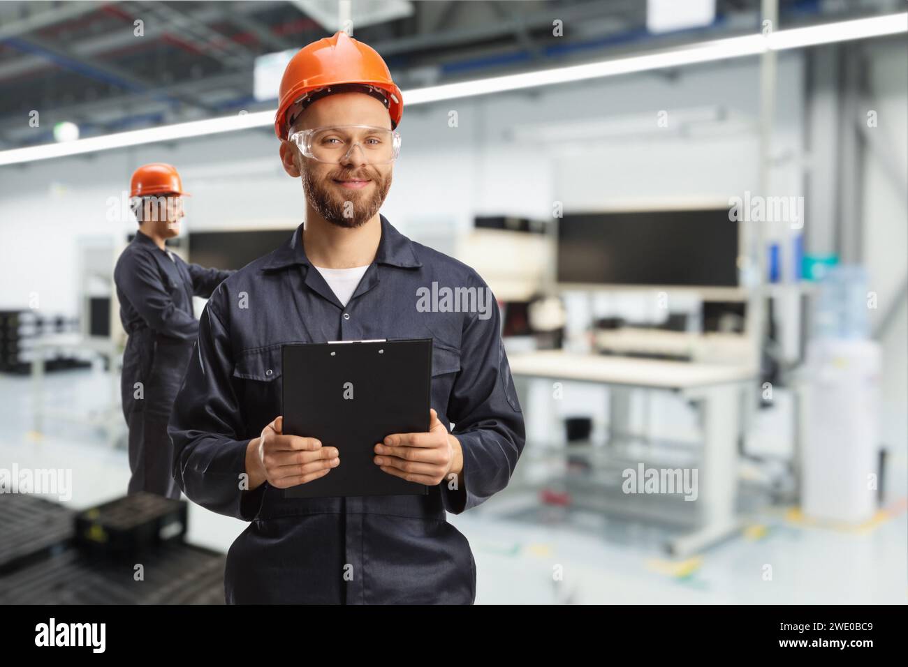 Factory workers working in a factory Stock Photo - Alamy