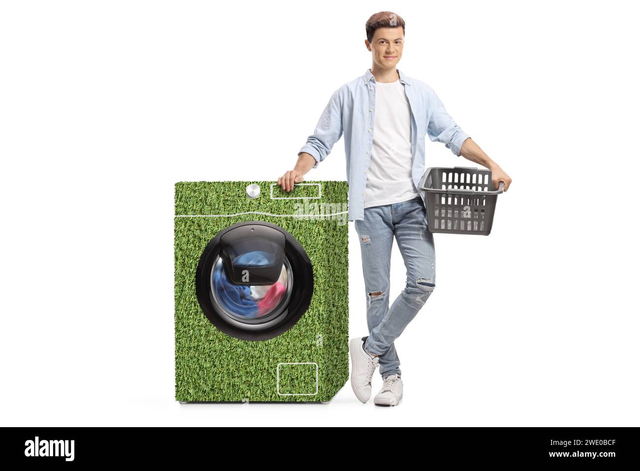 Guy holding a laundry basket and standing next to a green washing ...