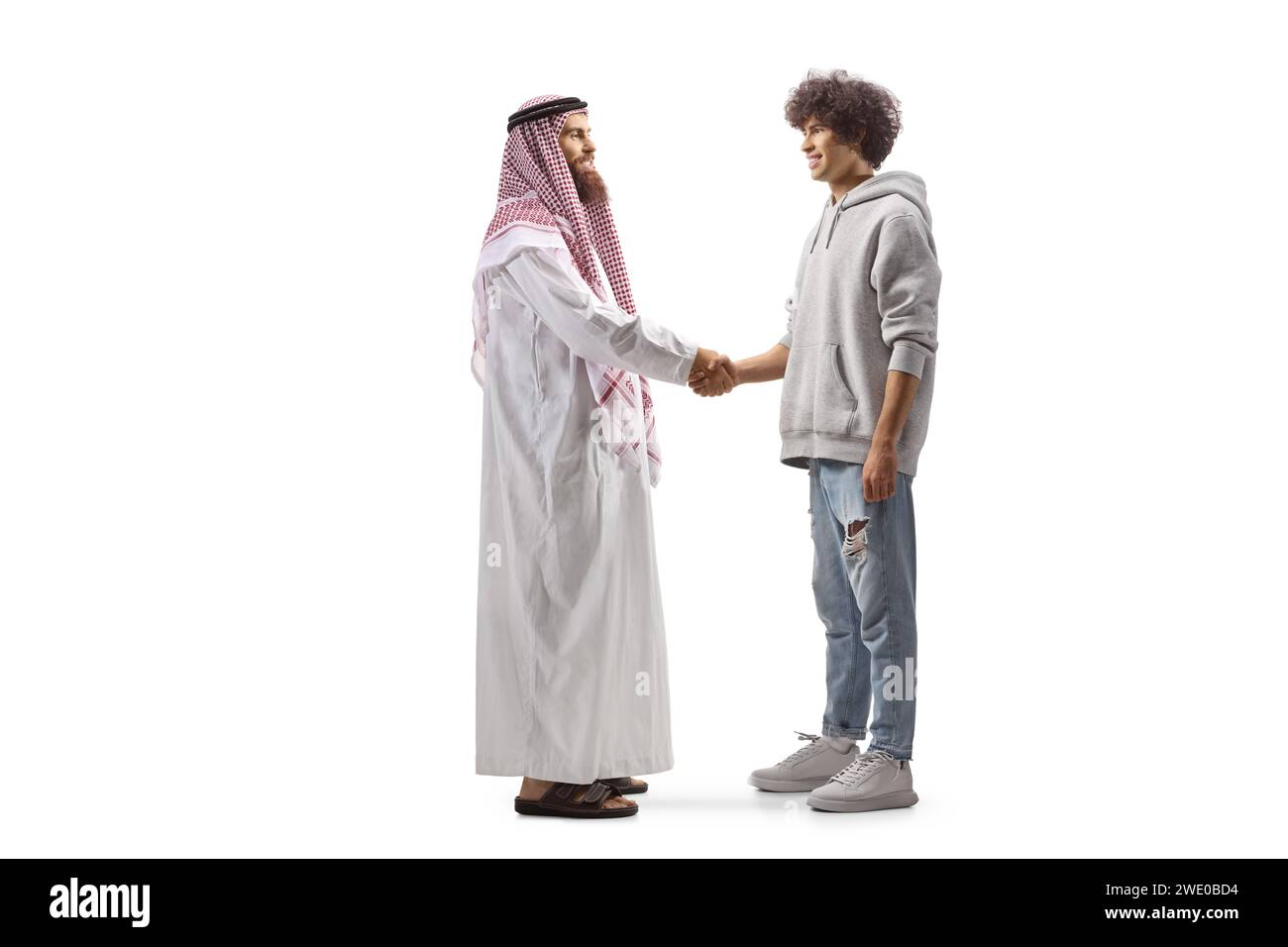 Saudi arab man meeting a young man and shaking hands isolated on white ...