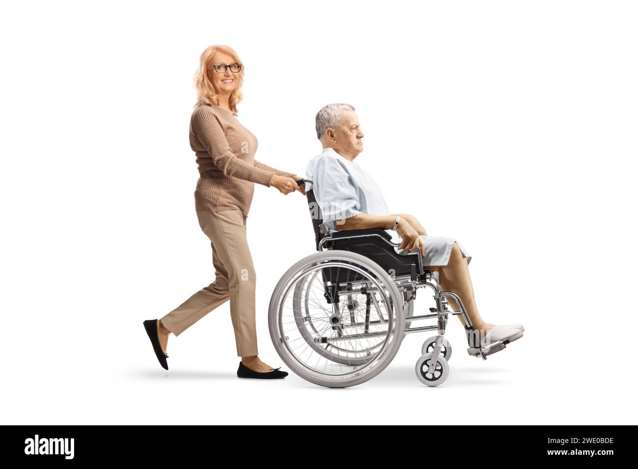 Woman pushing a patient in a wheelchair isolated on white background ...