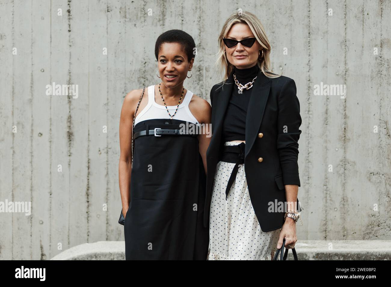 Tamu McPherson (L) wears a white top, long black strapless dress ...