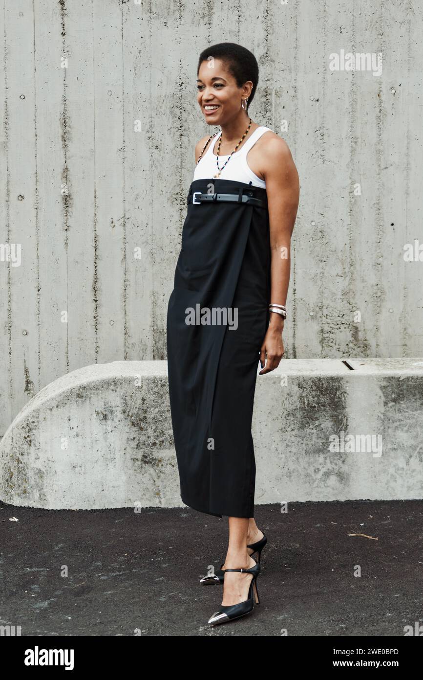 Tamu McPherson wears a white top, long black strapless dress, outside ...