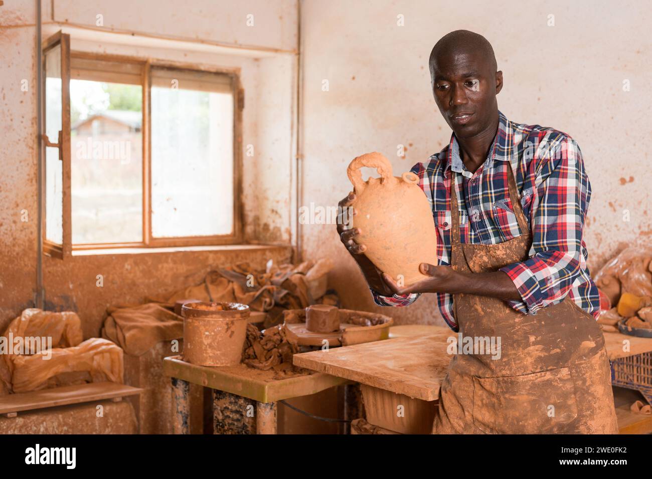 Potter checking clay products Stock Photo - Alamy