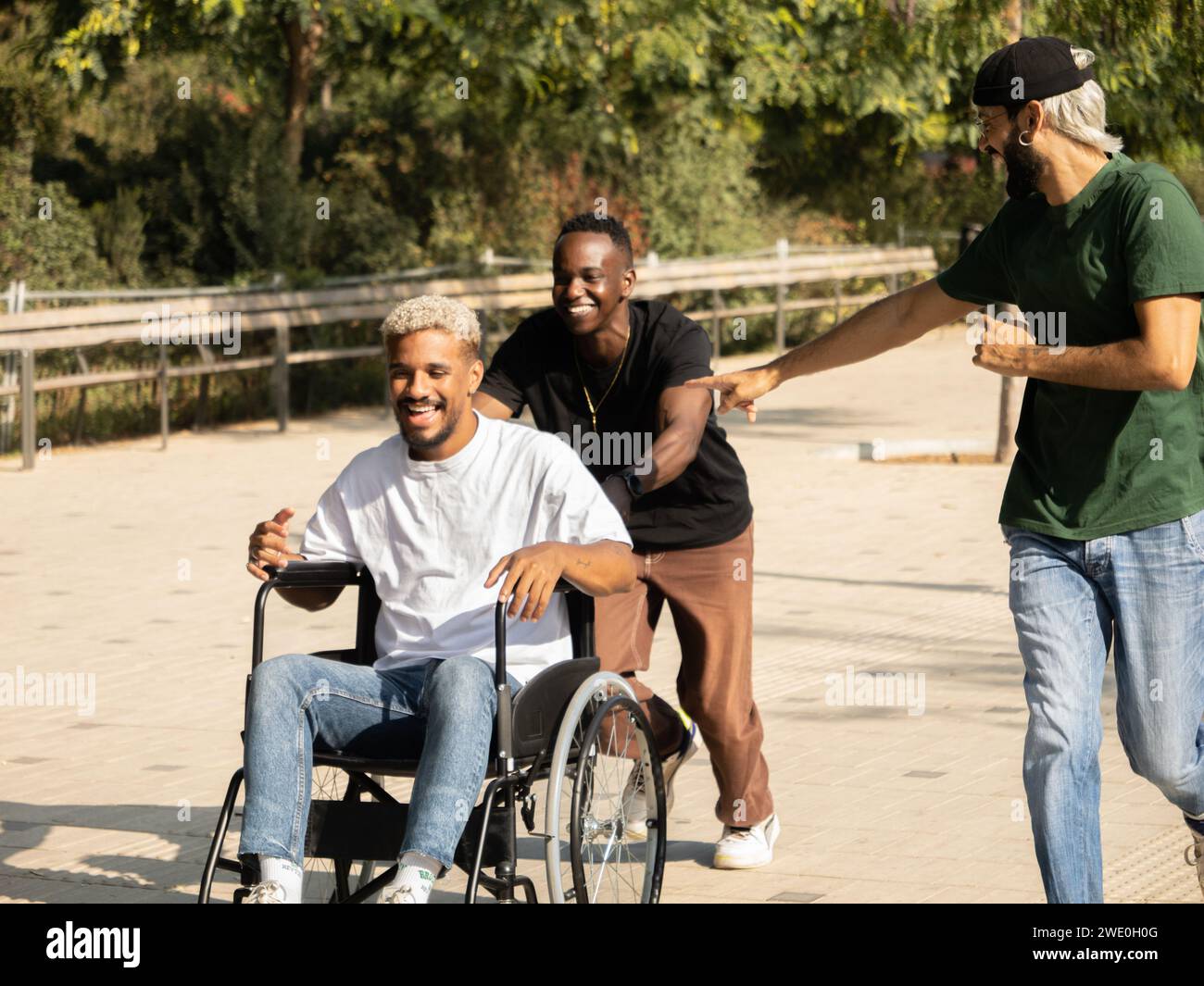 Group of diverse young male friends having fun one of them in a ...