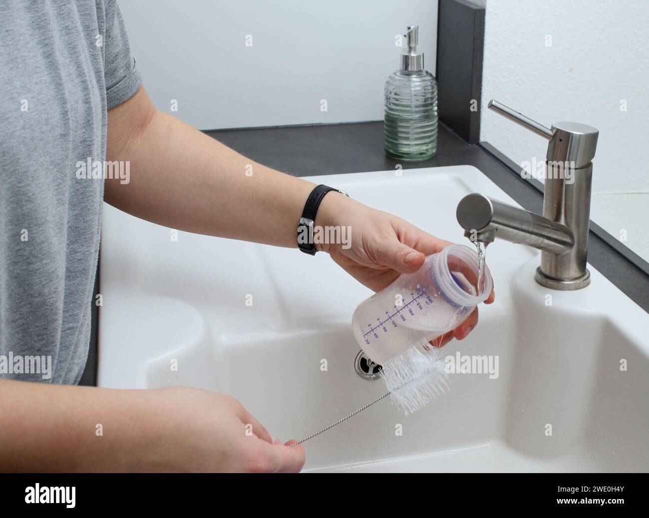Woman cleaning glass milk bottle hi-res stock photography and images ...